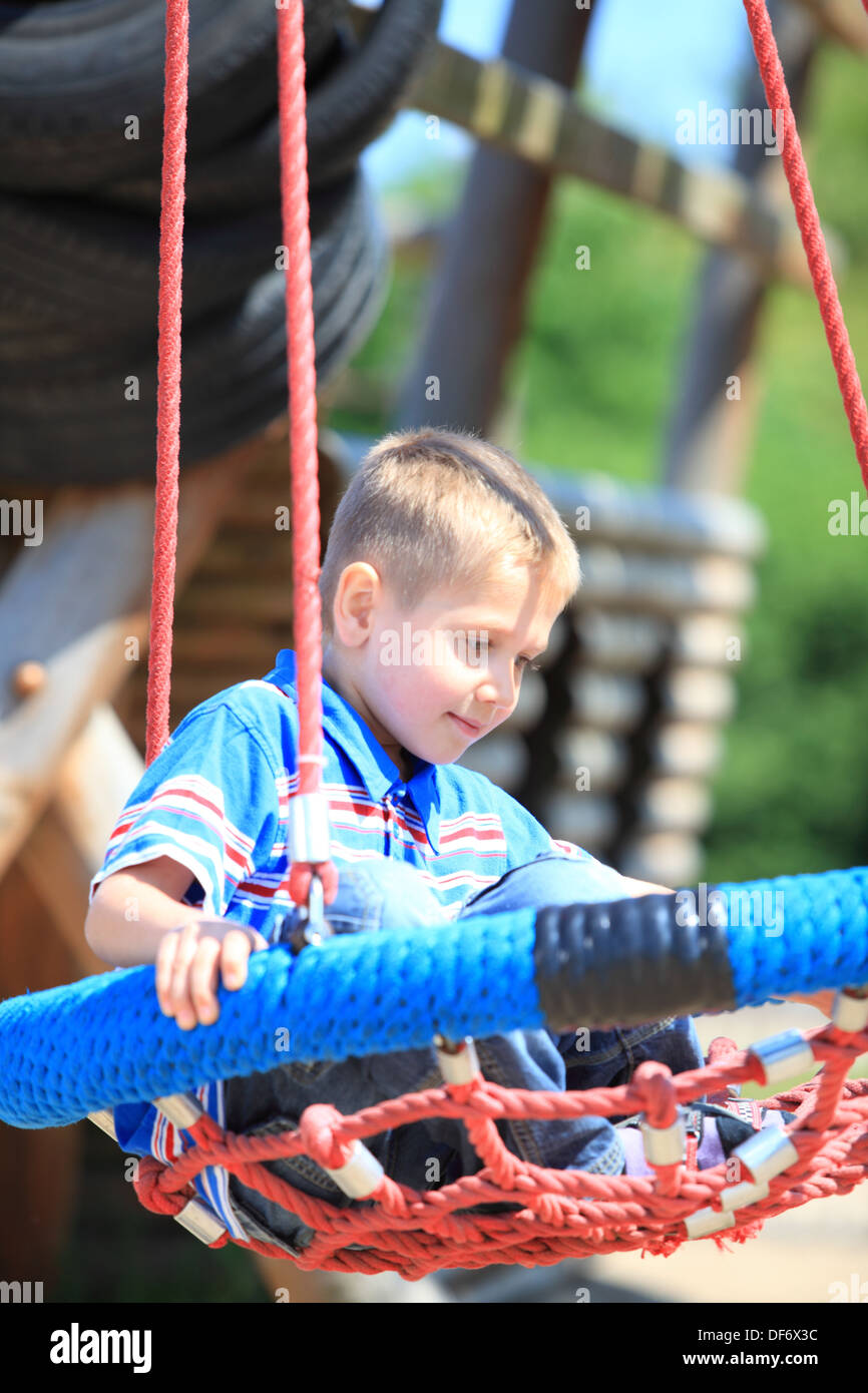 young child boy or kid playing in playground on leisure equipment Stock ...