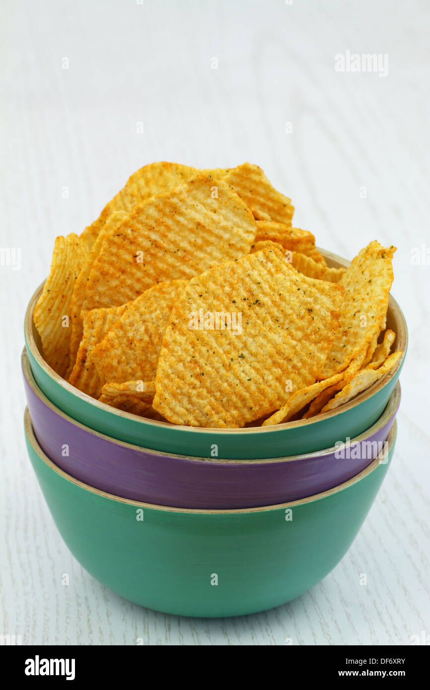 Baked potato crisps in colorful bamboo bowl with copy space Stock Photo ...