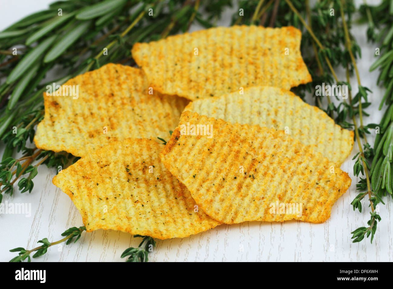 Baked potato crisps with fresh herbs, closeup Stock Photo - Alamy