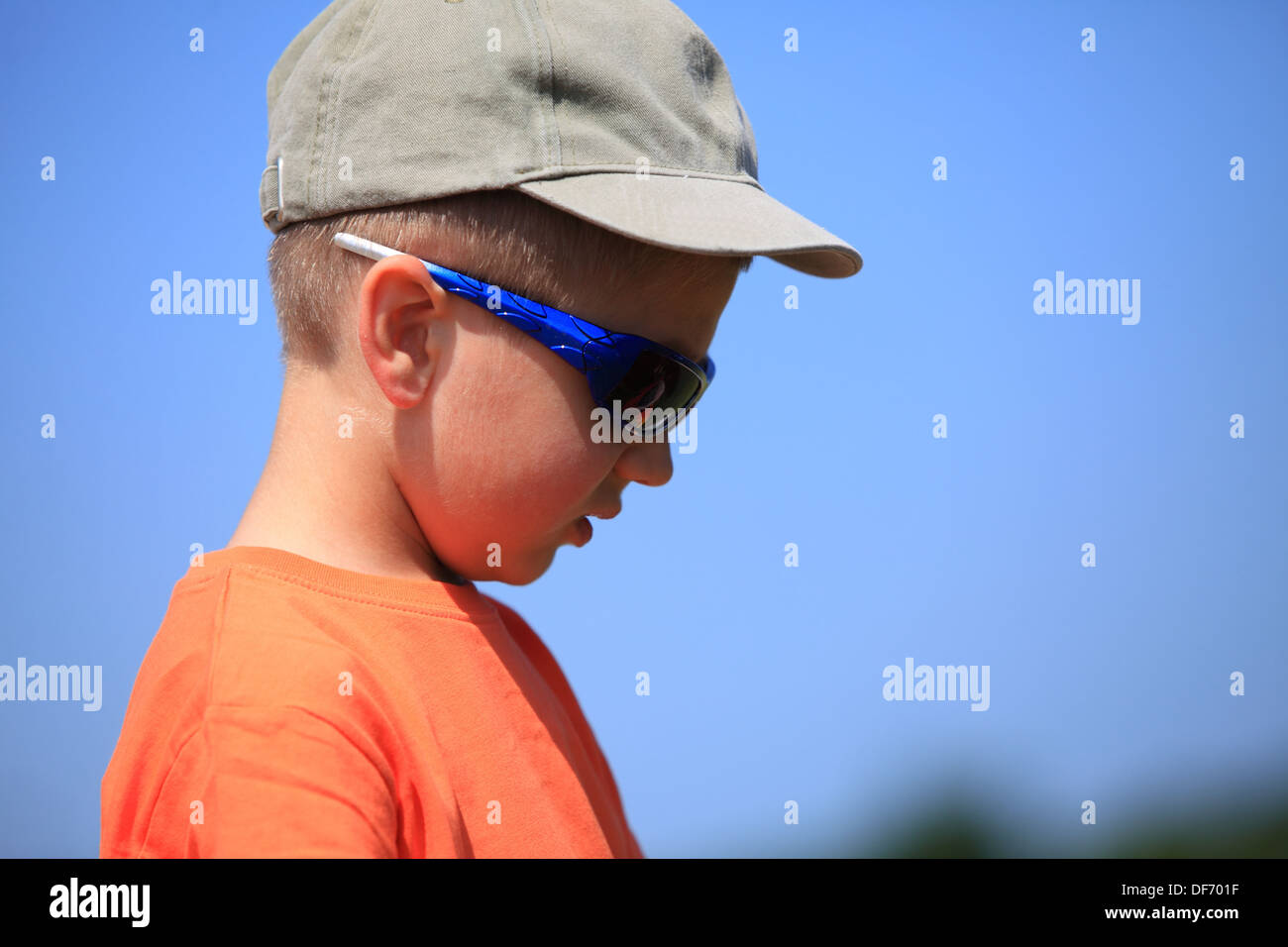 Little boy kid with sunglasses and cap outdoor sky background Stock ...