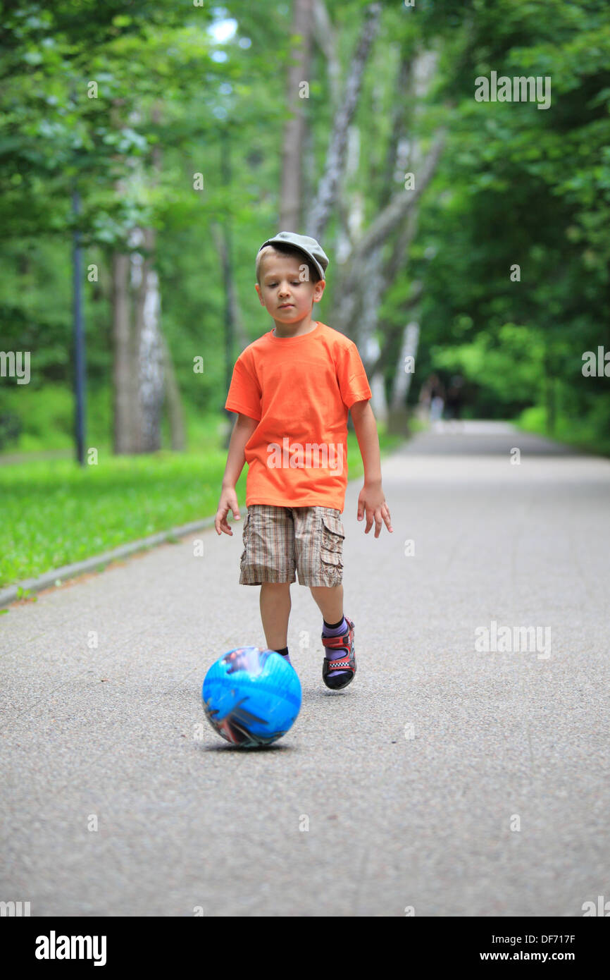 Child running ball road hi-res stock photography and images - Alamy