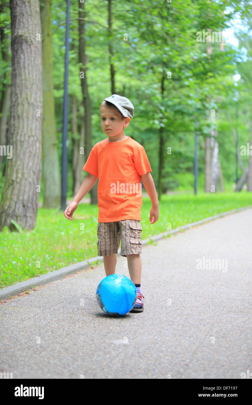 Child running ball road hi-res stock photography and images - Alamy