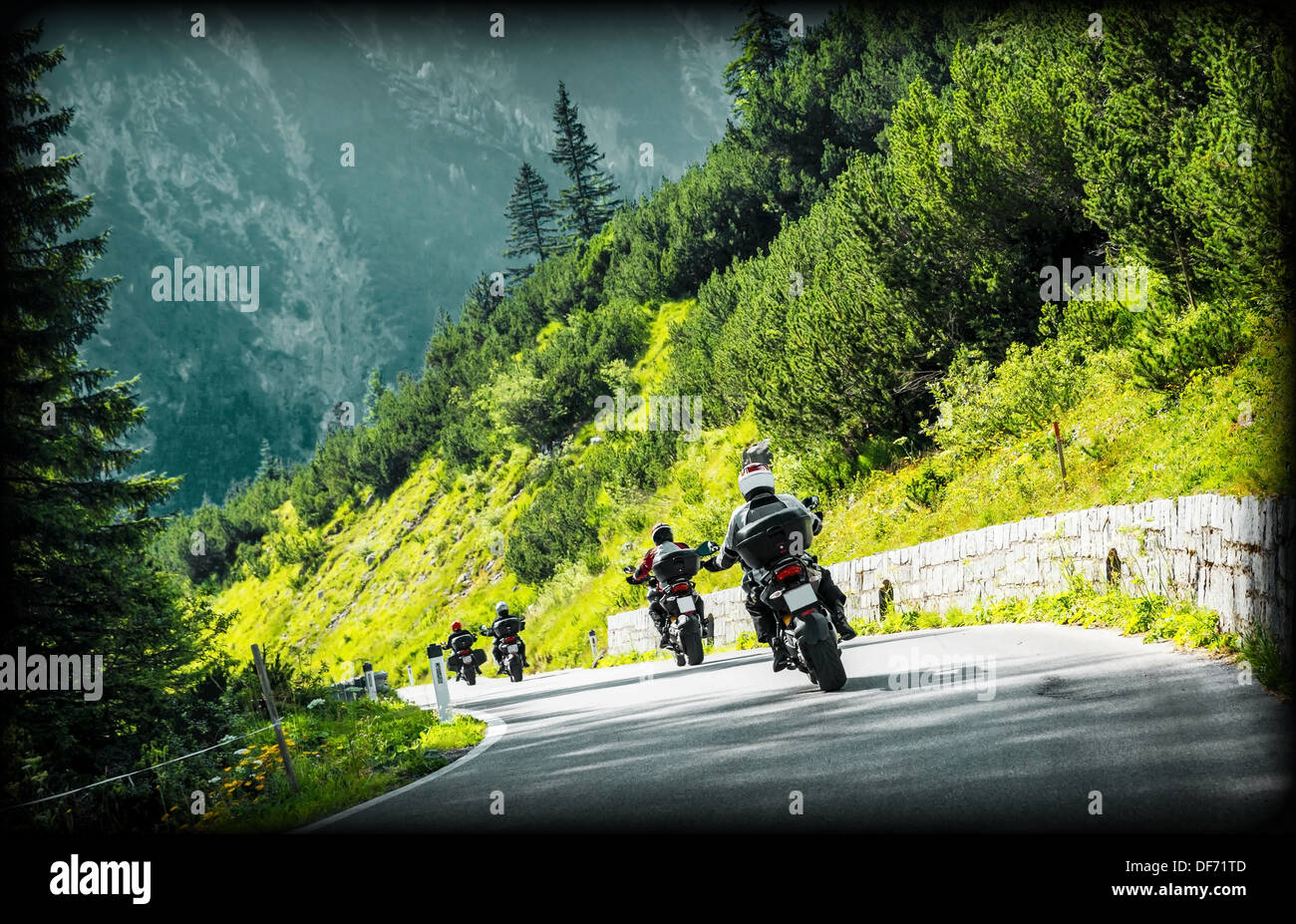 Group of moto bikers on mountainous highway, riding on curve road pass ...