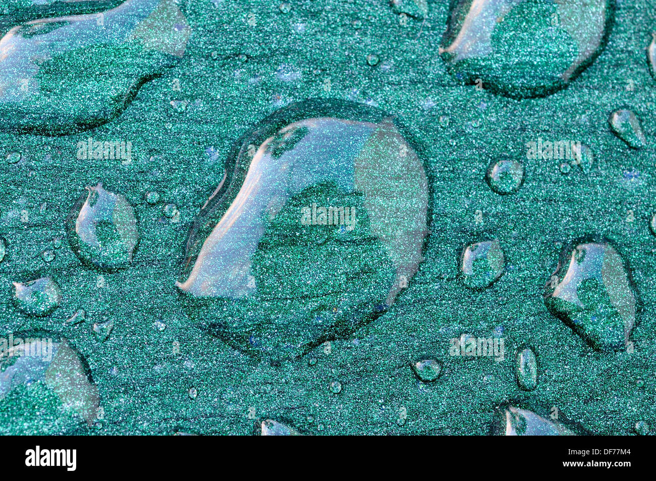 Rain spots on a green metallic tabletop Stock Photo - Alamy