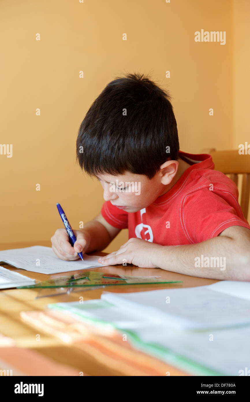 boy doing school homework from mathematics in workbook Stock Photo - Alamy