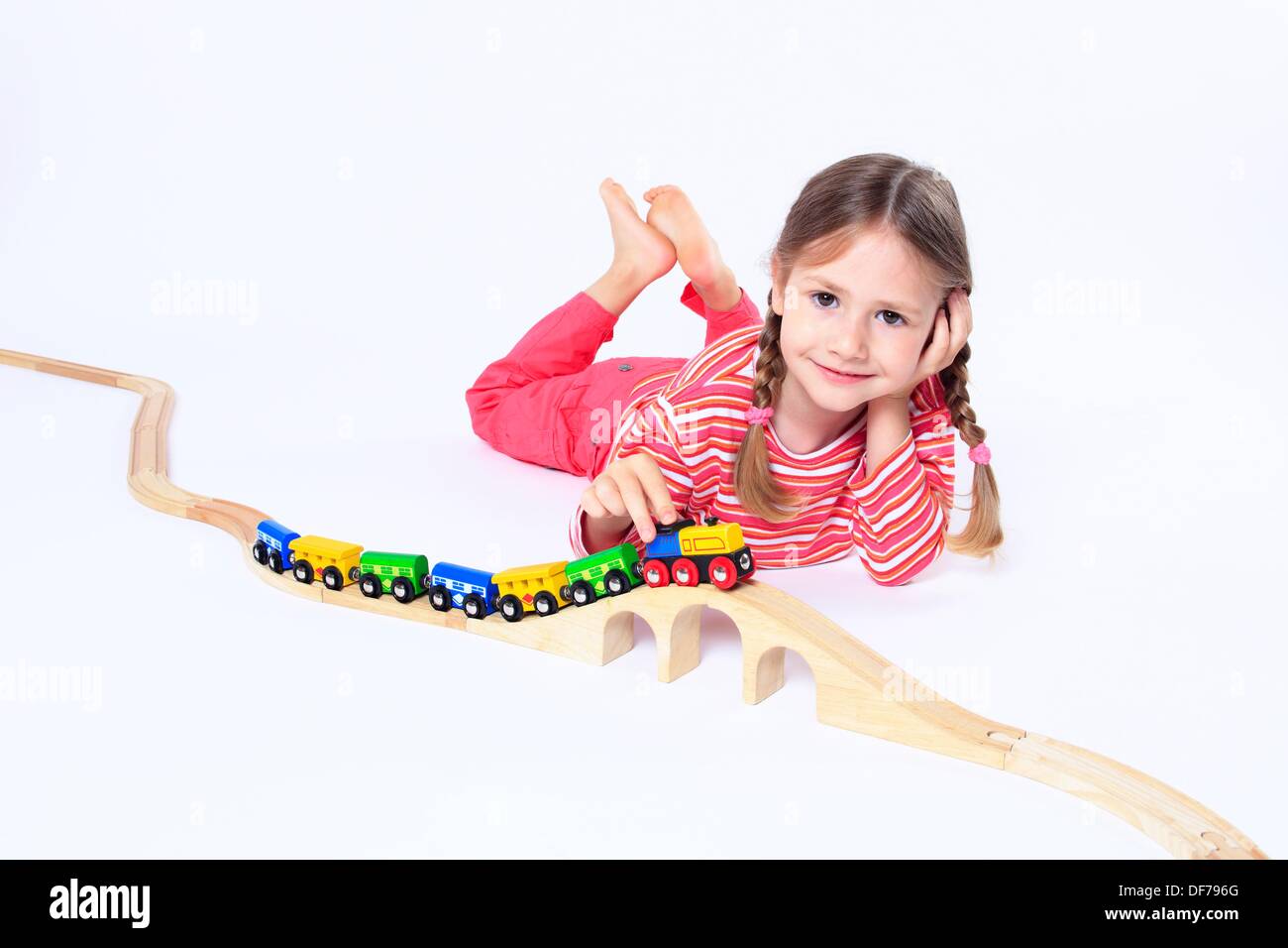 Child lying down playing with toy train hi-res stock photography and ...