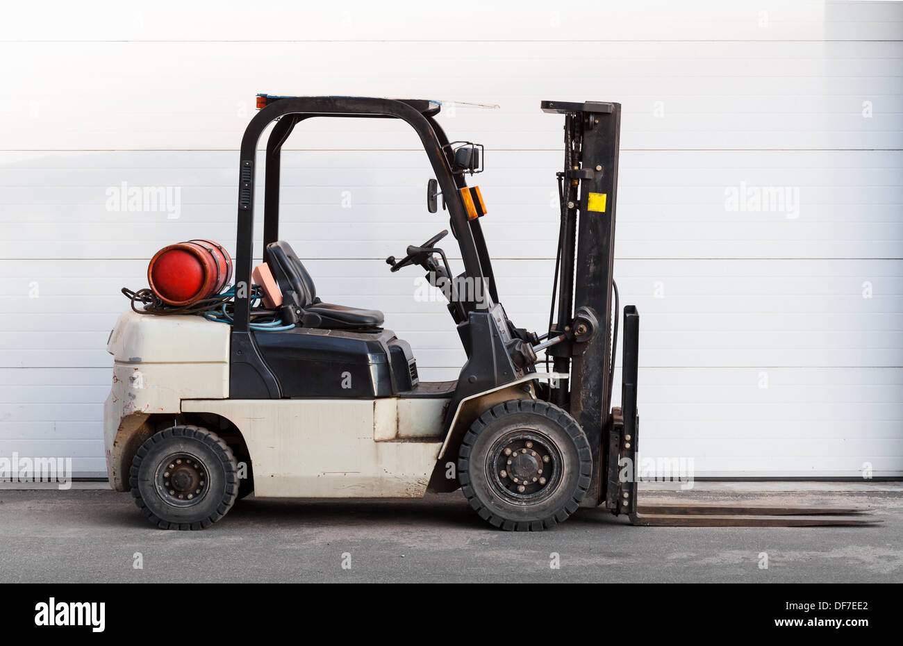 Standard small gas engine truck lift above gray storage gate Stock ...