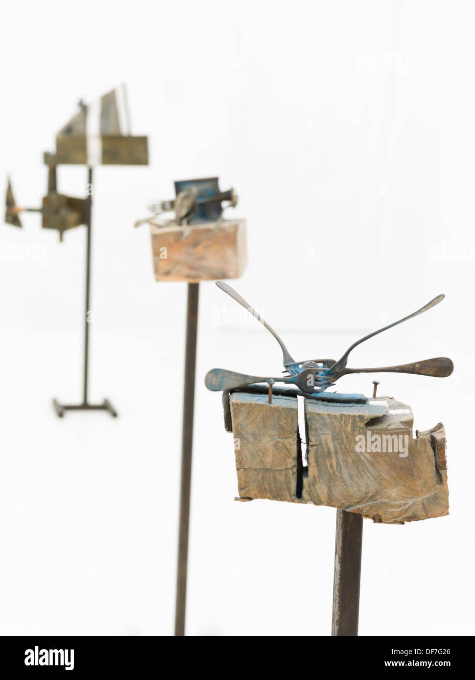 close-up of group of three contemporary artworks on white background ...