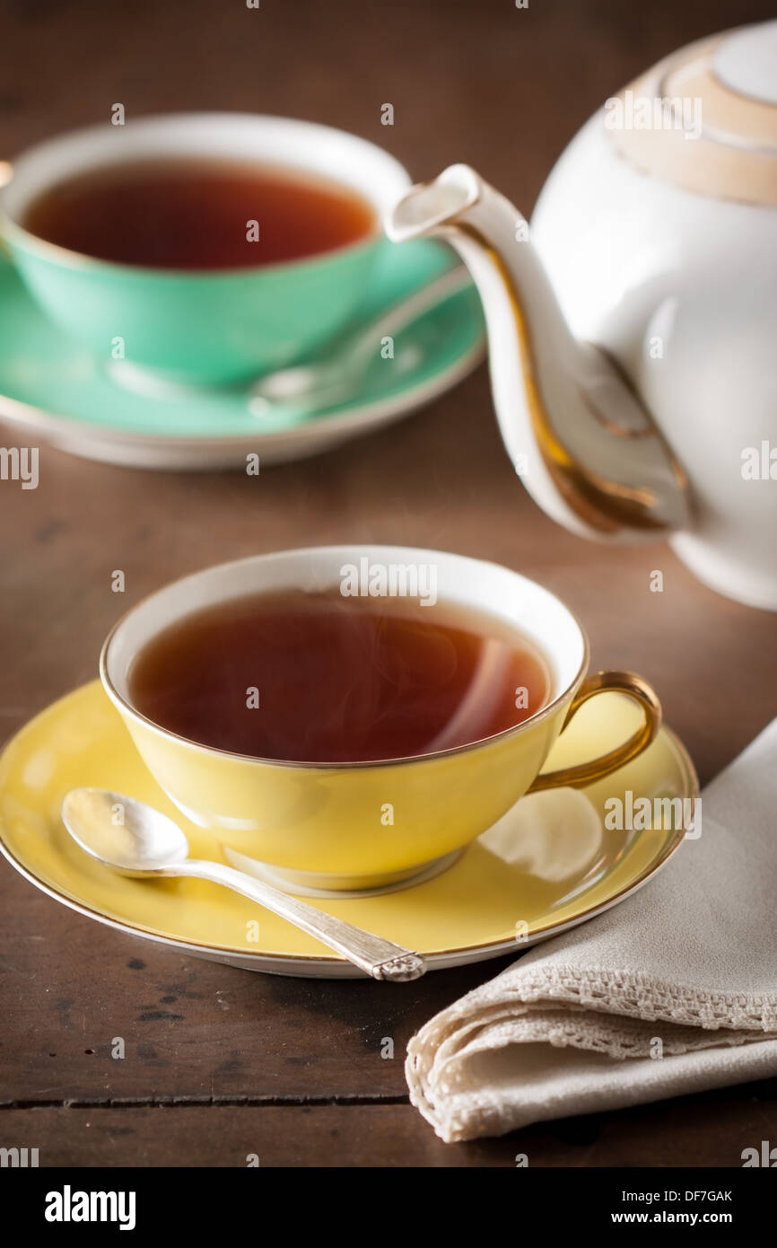 Serving tea with vintage teapot Stock Photo - Alamy
