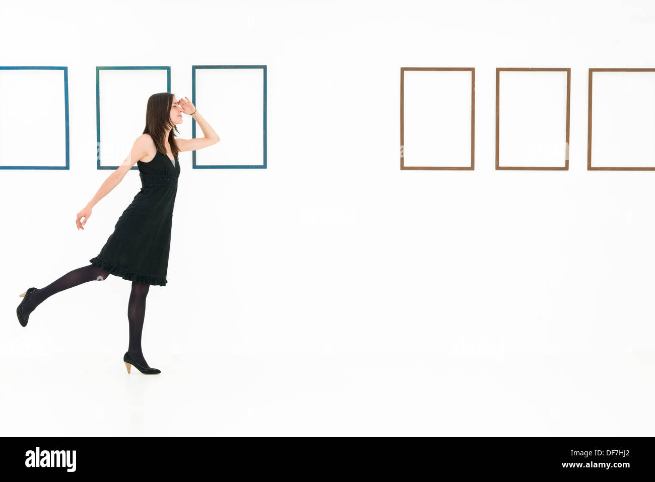 side view of caucasian woman looking far away, standing in front of ...