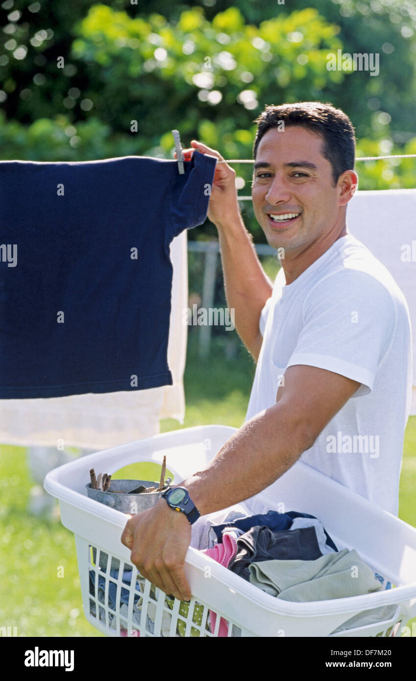 Man hanging up washing hi-res stock photography and images - Alamy