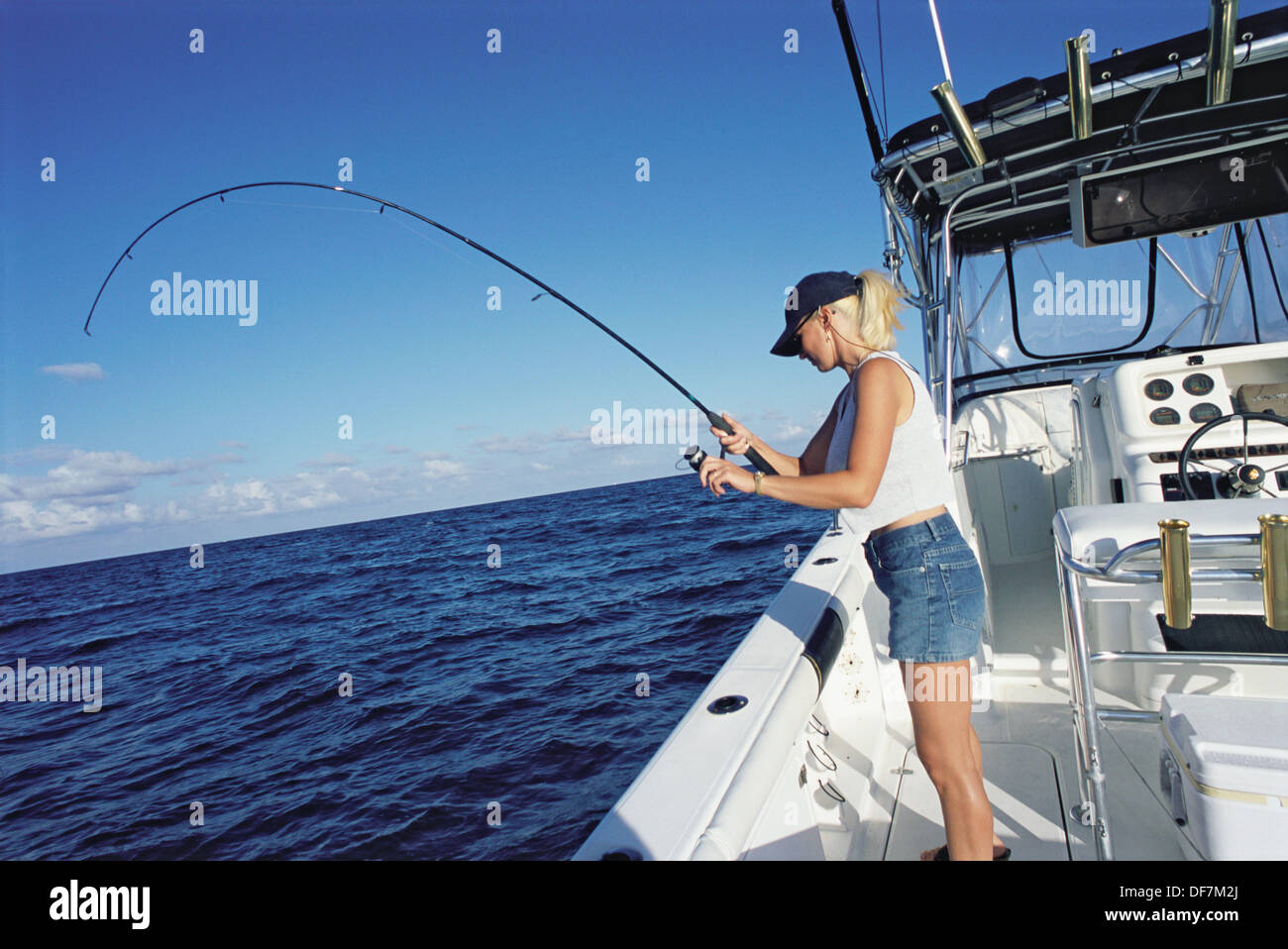 Young Woman Catching A Fish With Rod High Resolution Stock Photography ...