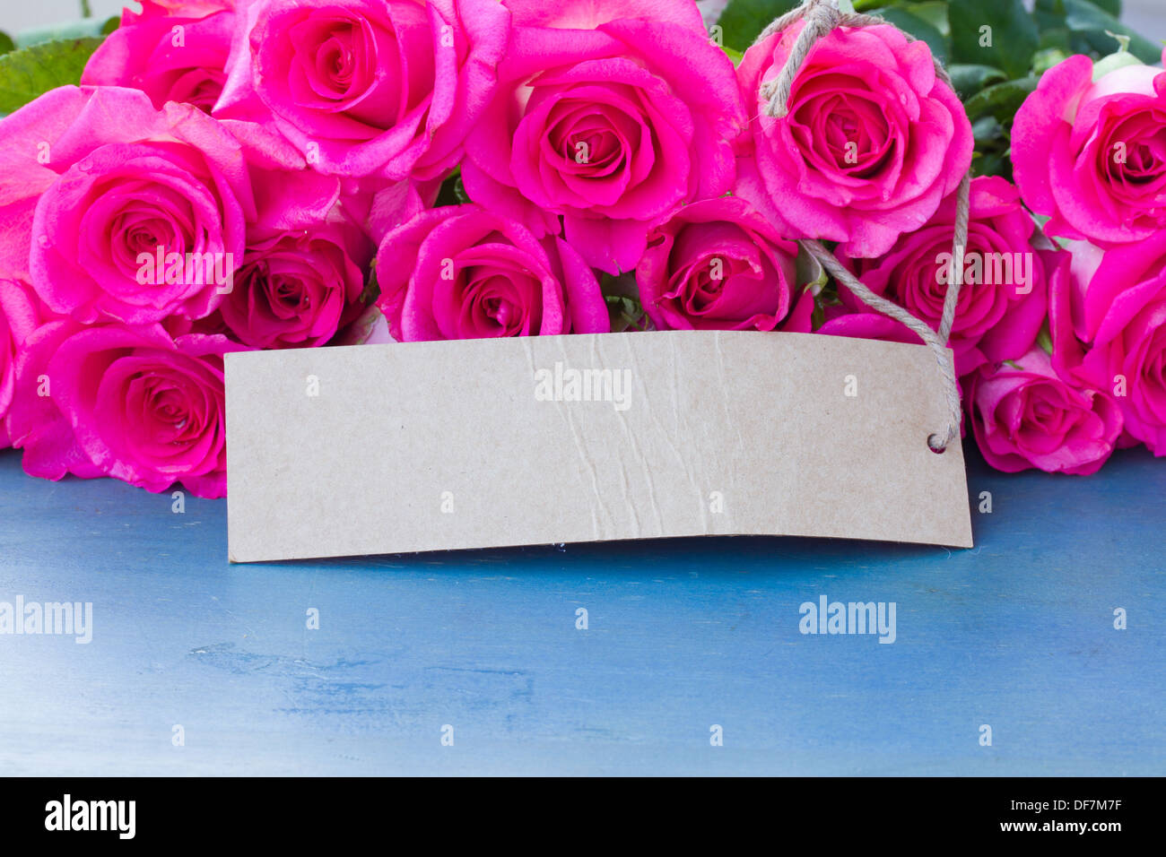 pink roses with tag Stock Photo - Alamy