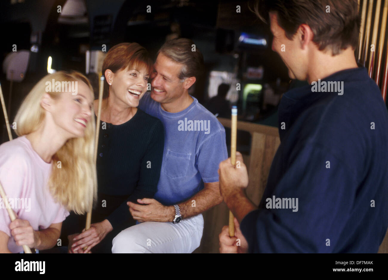 friends shooting pool Stock Photo - Alamy