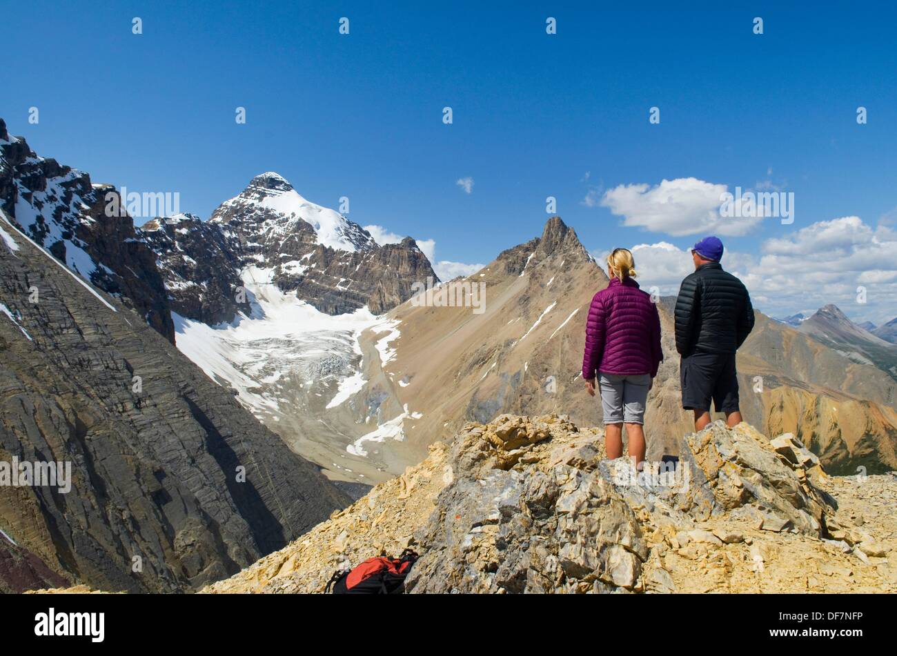 Hikers admiring view from summit of Parker Ridge, Mount Atahbasca is in ...