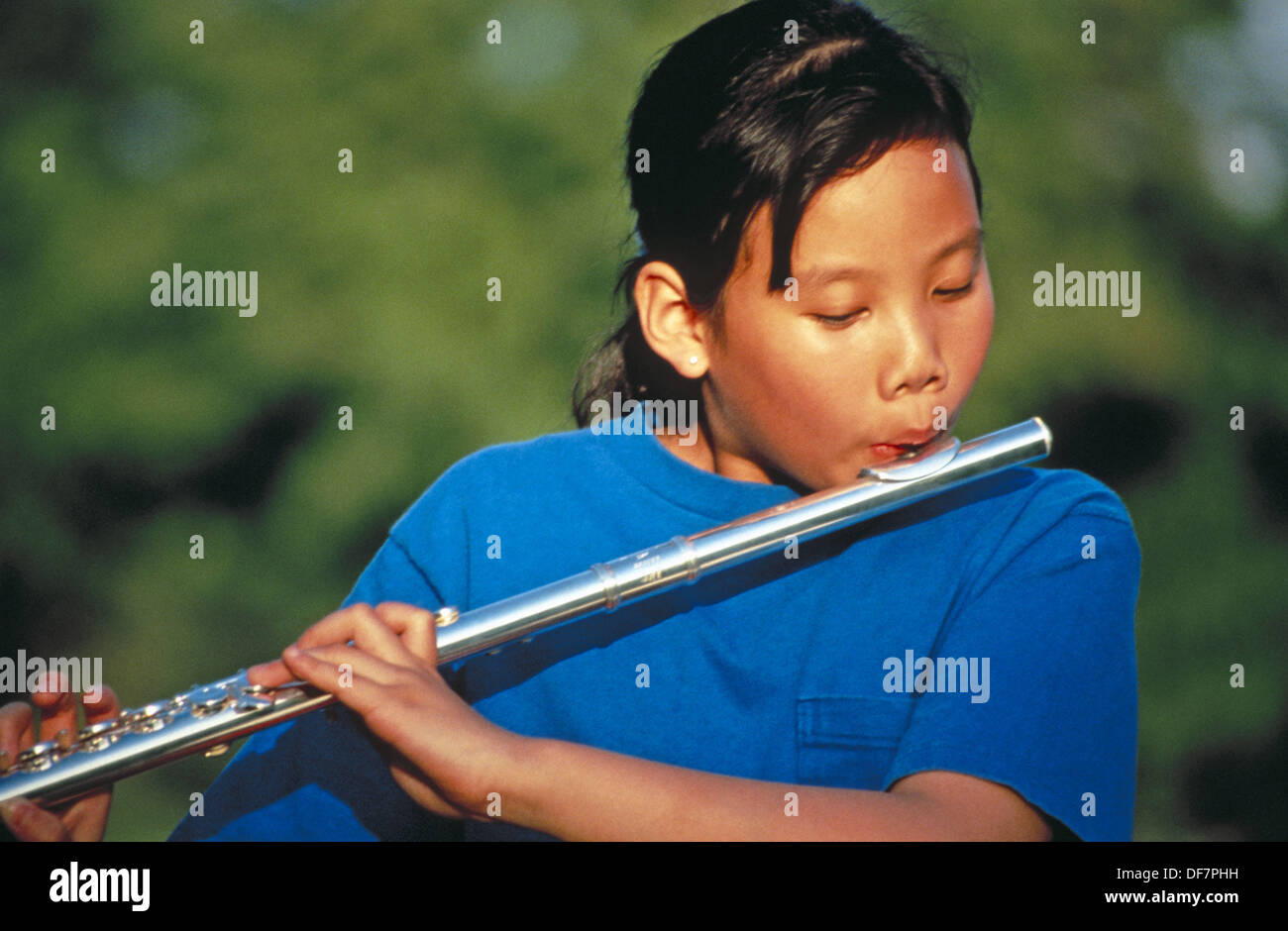 Teen girl playing flute hi-res stock photography and images - Alamy