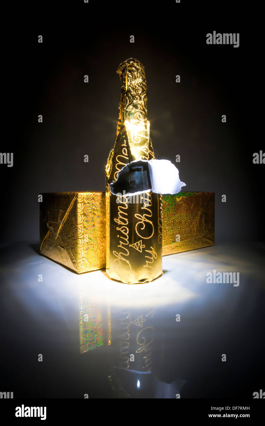 Gift wrapped Champagne bottle and box, paper torn to show bottle Stock ...