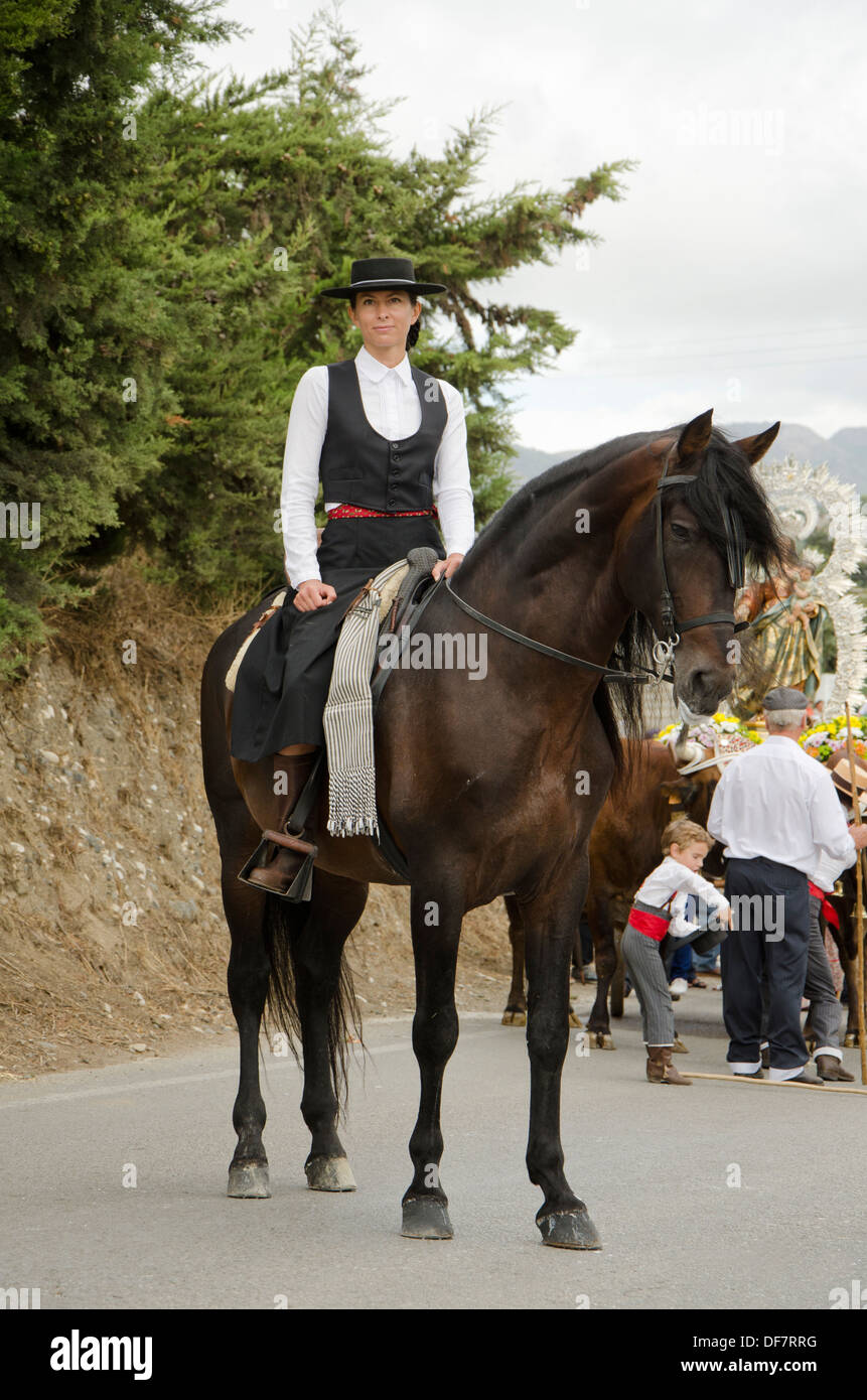 Woman on horse in traditional flamenco dress during an andalusian ...