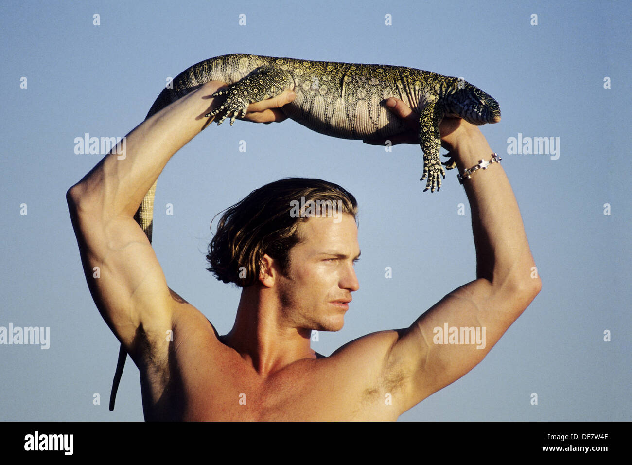 Man with monitor lizard hi-res stock photography and images - Alamy