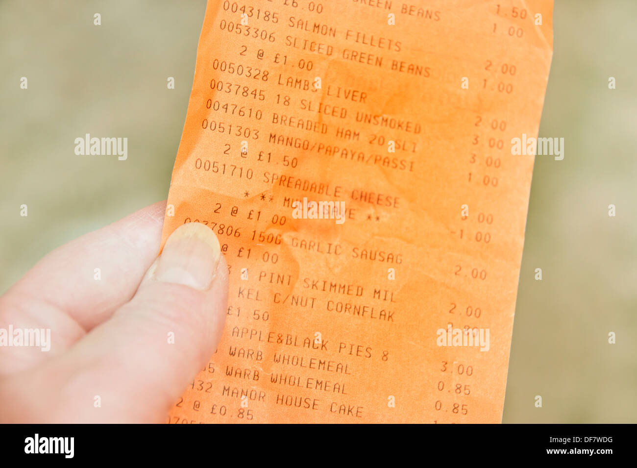 Woman checking prices of shopping looking at till receipt bill from ...