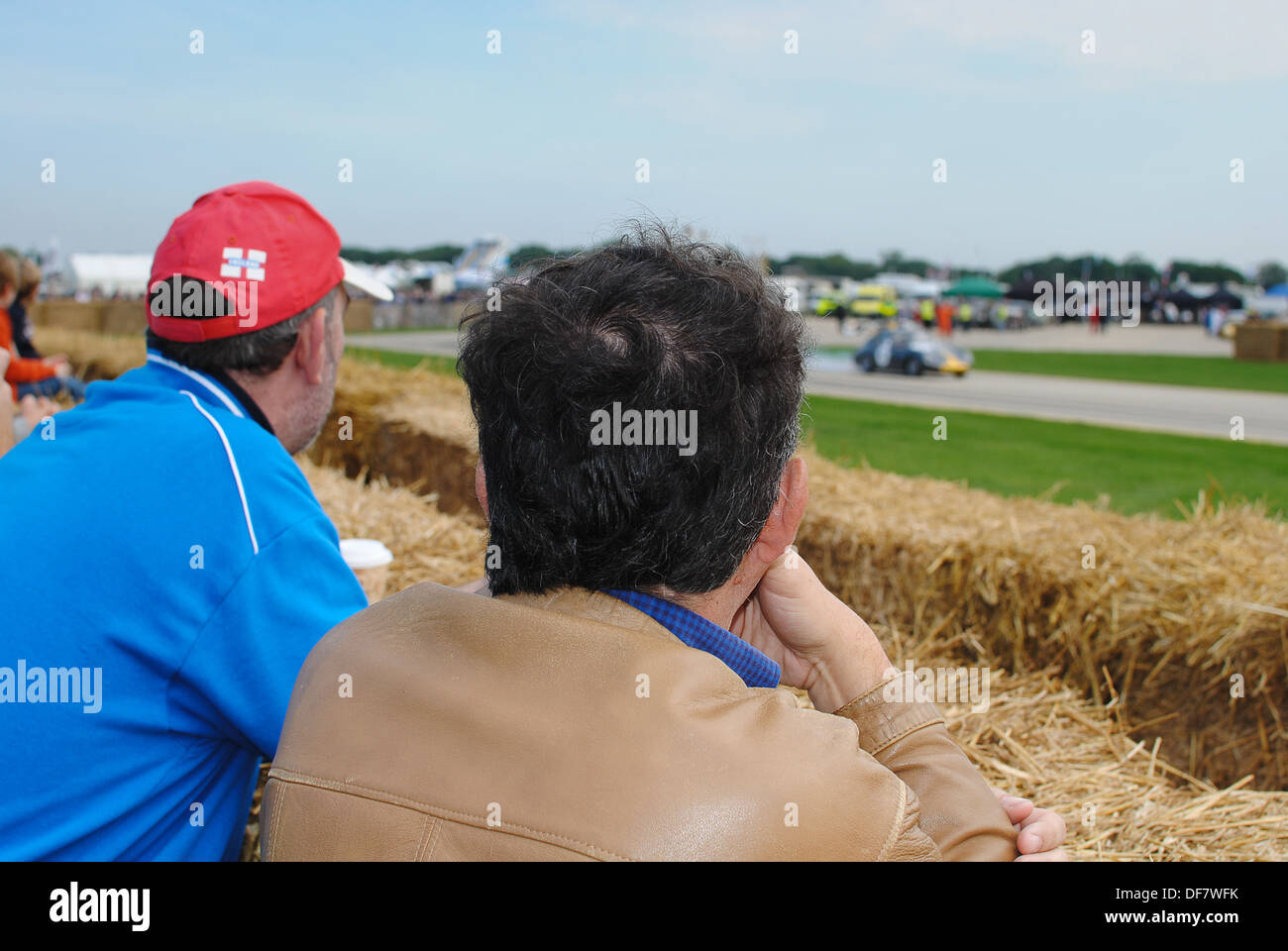 Male spectators watching motor sport Stock Photo - Alamy