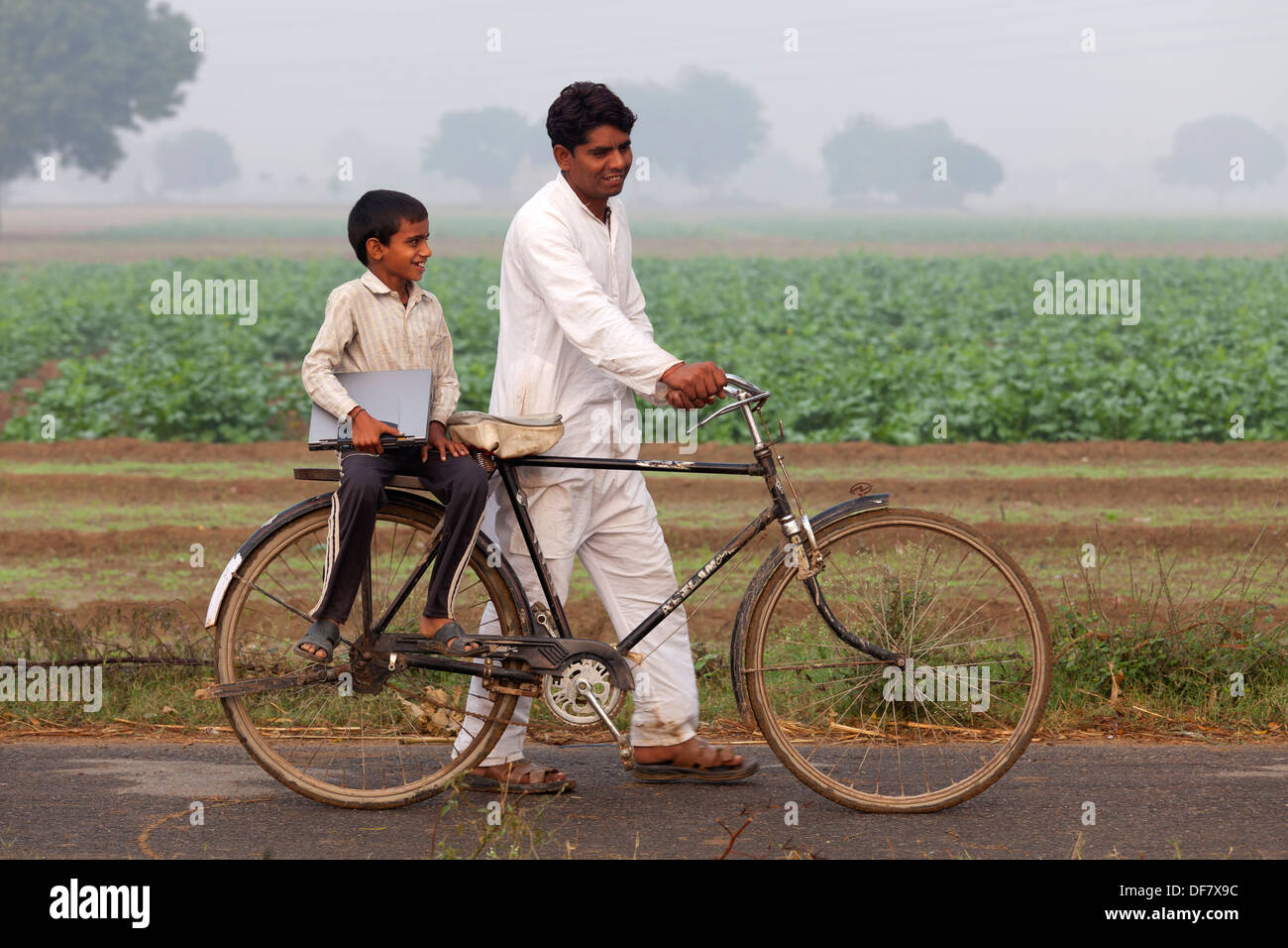 Indian boy pushing bike india hi-res stock photography and images - Alamy