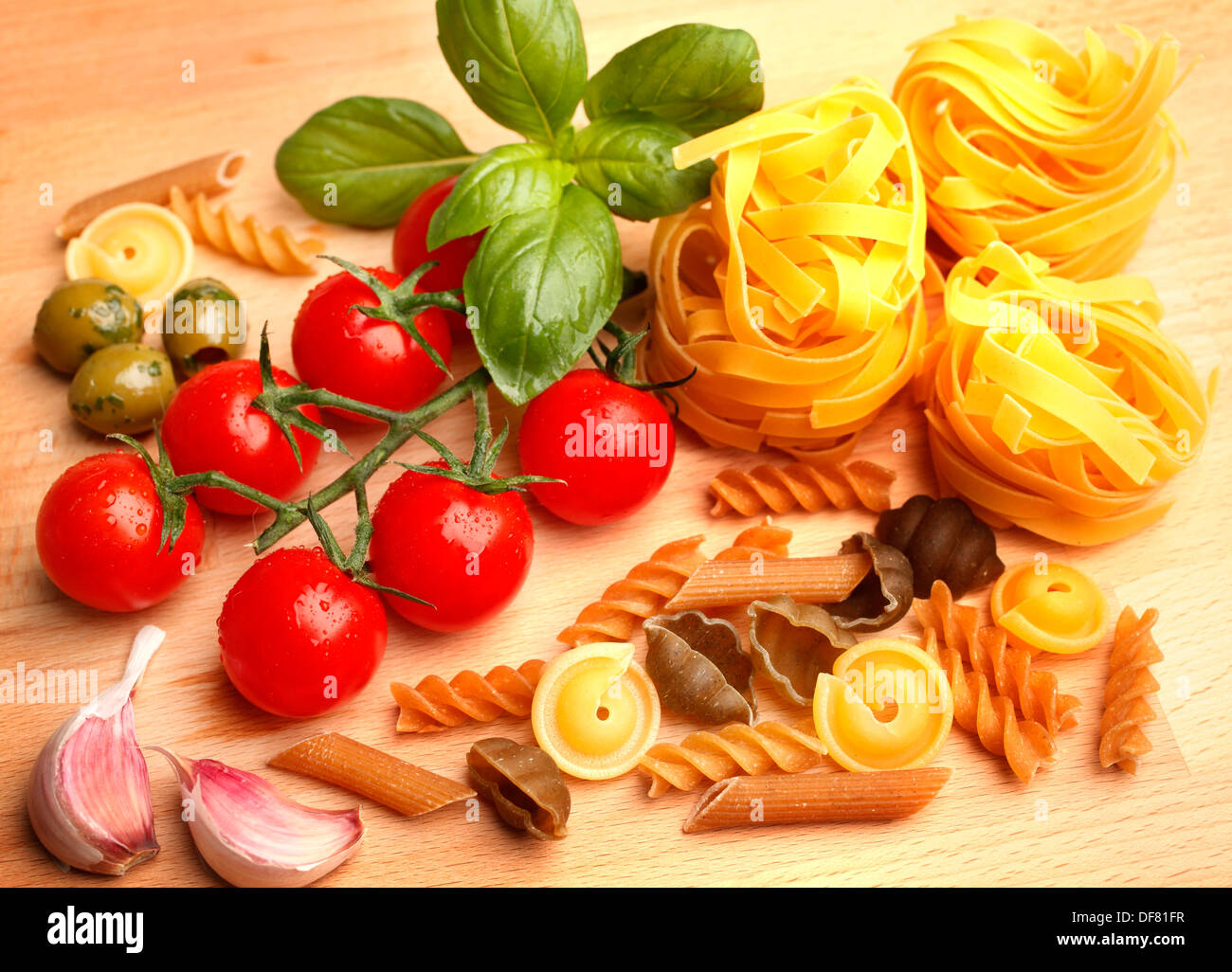 Italian food. Garlic, fresh basil, tomatoes, pasta and tagliatelle ...