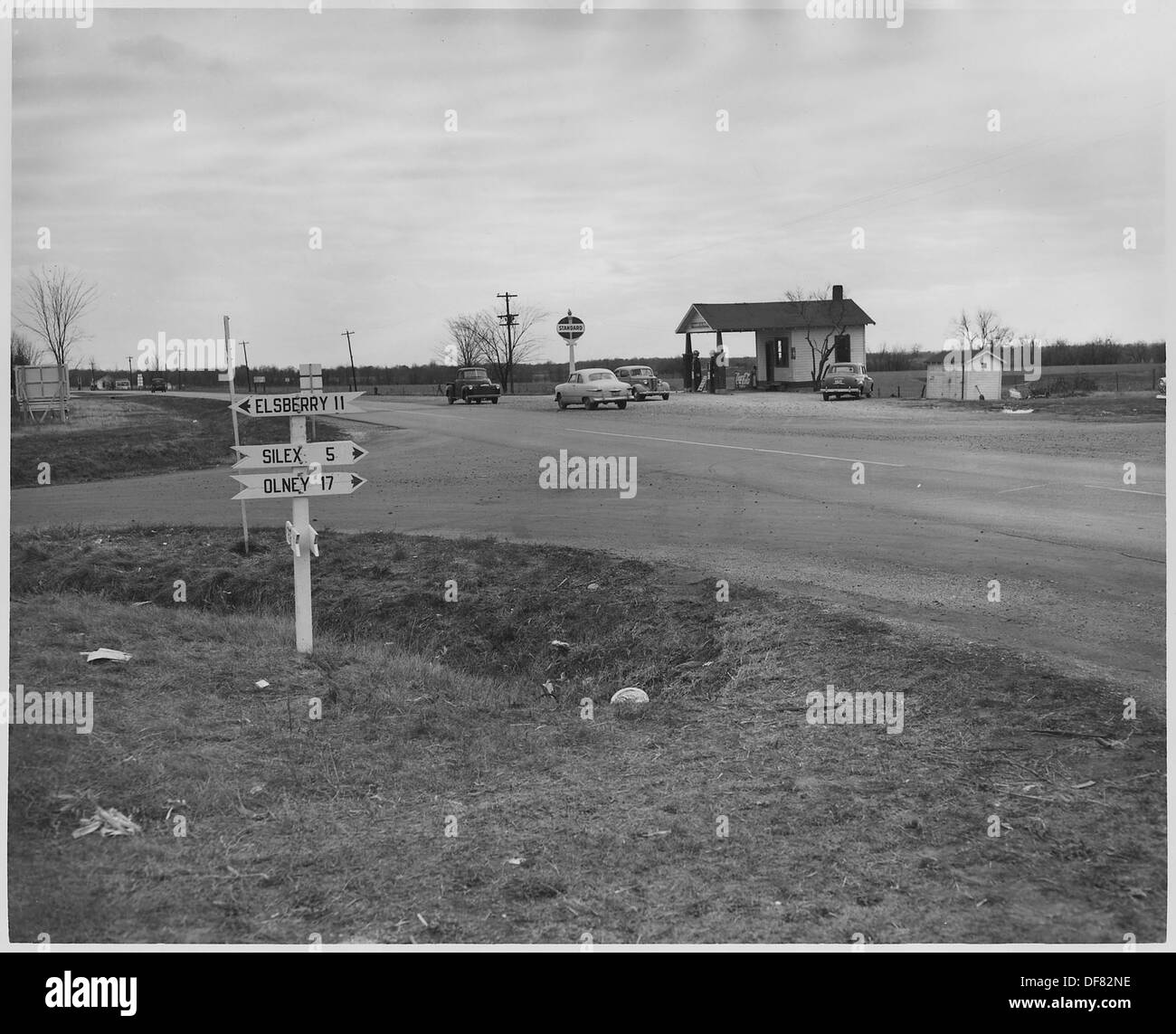 This image shows a road intersection and a Standard service station ...