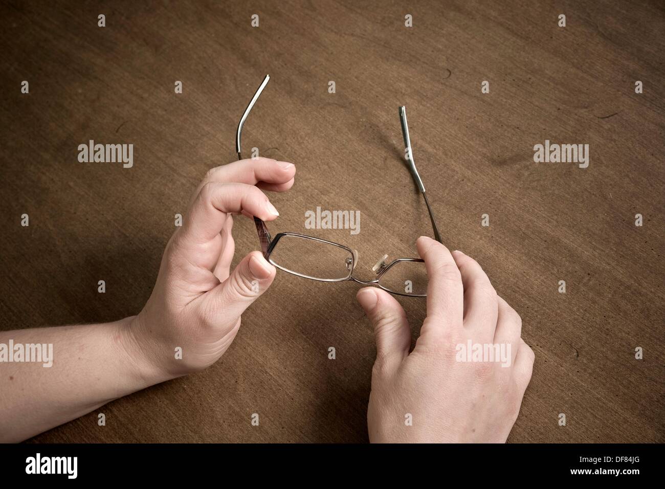 Young woman´s hands holding her glasses Stock Photo - Alamy