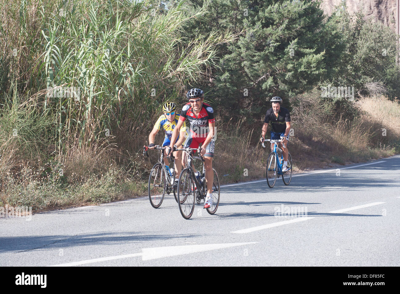 3 cyclists enjoying riding bikes Stock Photo - Alamy