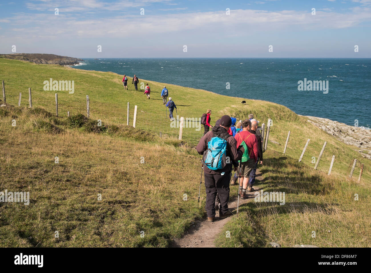 Group of Ramblers walking west on the coastal path from Llaneilian ...