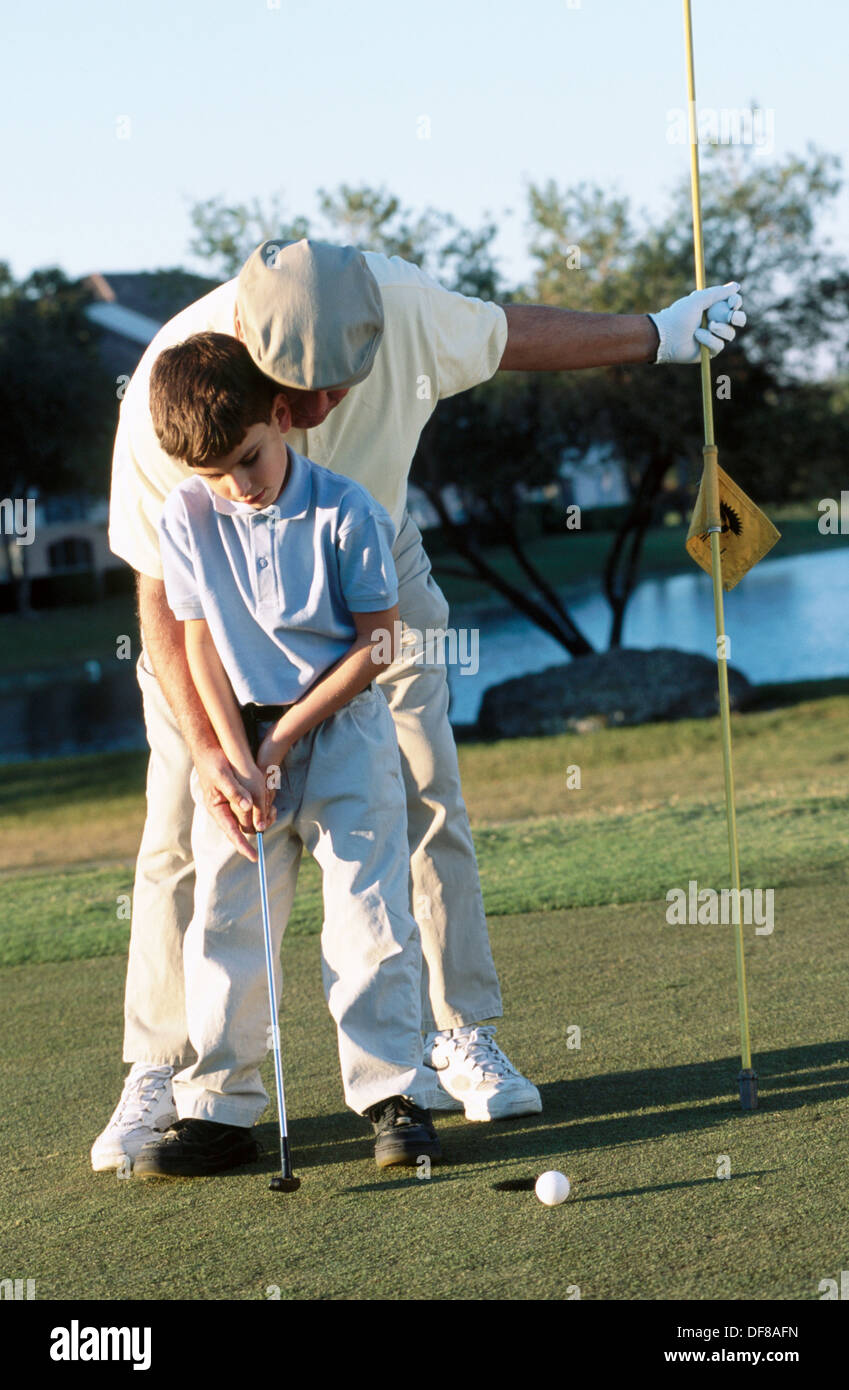 Child learning to play golf hi-res stock photography and images - Alamy