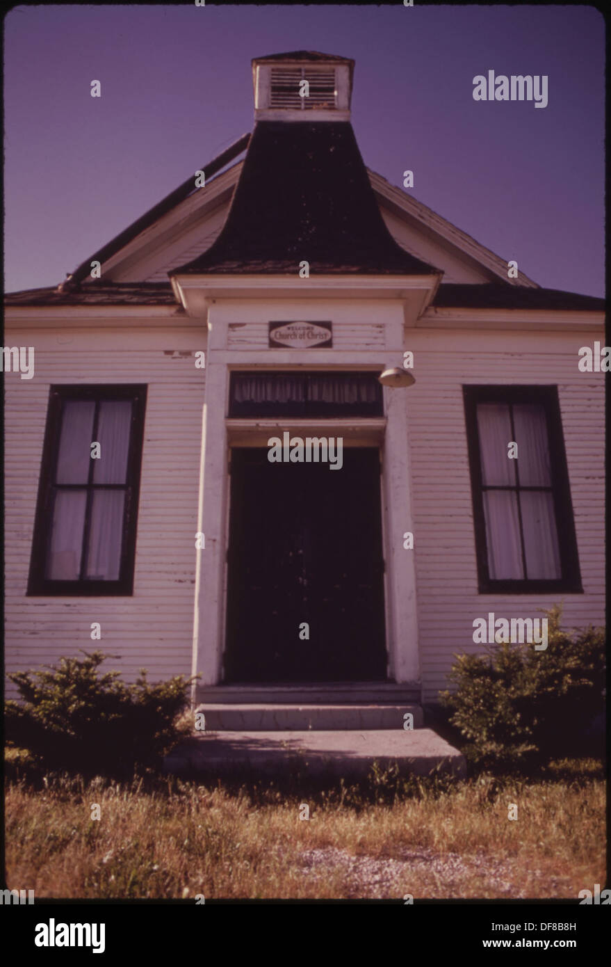A small country church in a rural setting, reflecting simple ...