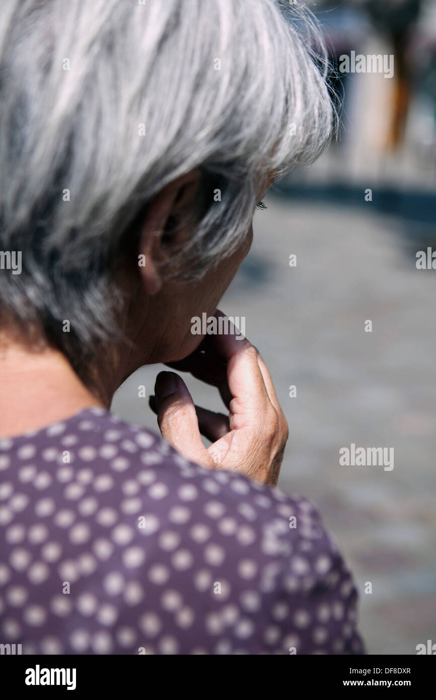 Old person sitting down hi-res stock photography and images - Alamy