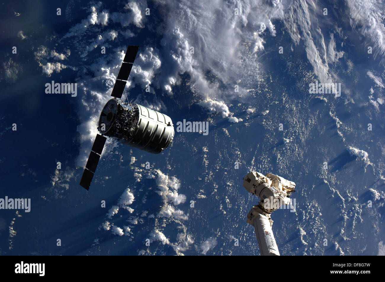 The International Space Station robotic arm reaches out to grab the ...