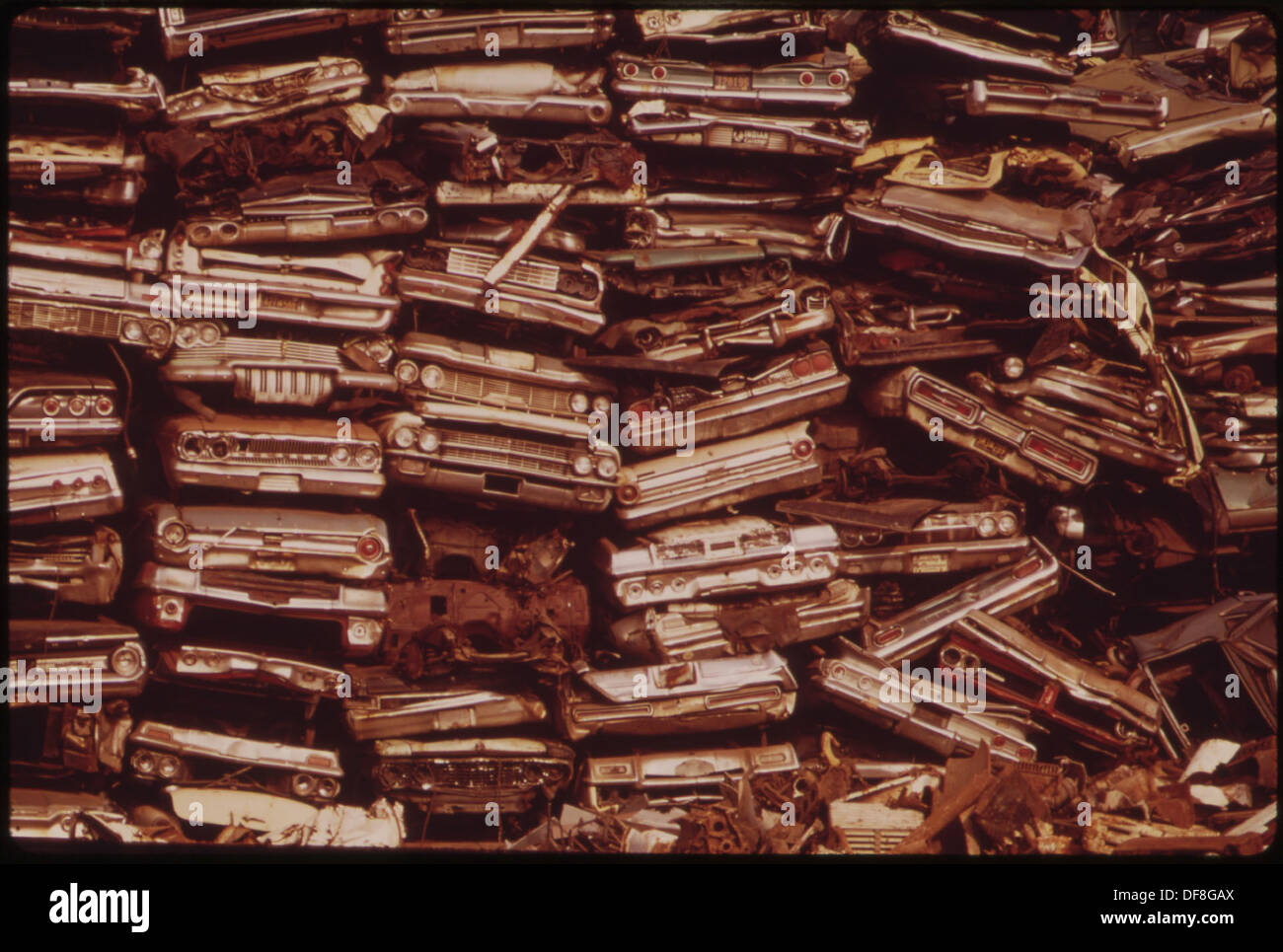 This image shows stacked cars in a city junkyard, ready to be processed ...