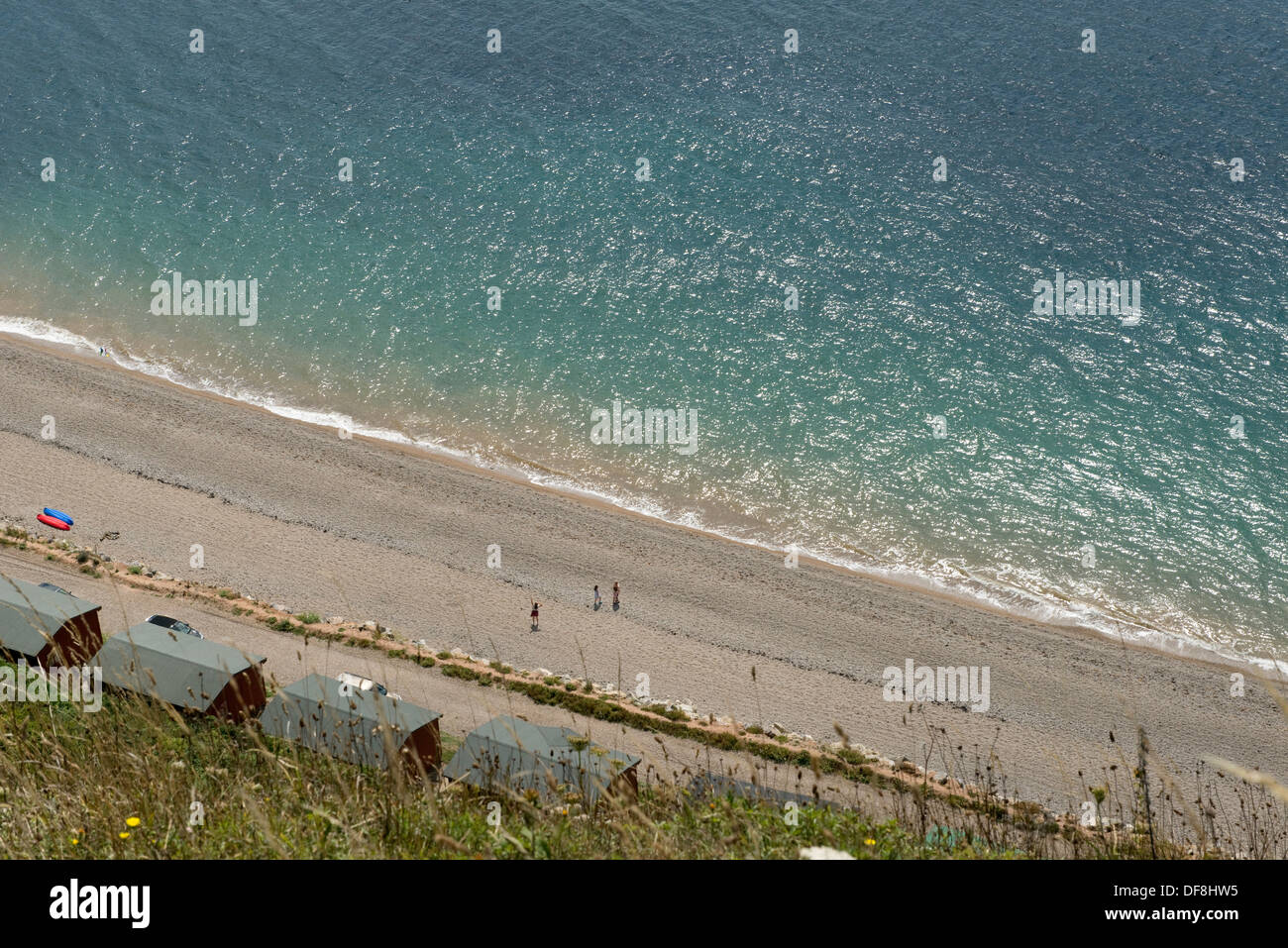 Branscombe beach shingle, sand, blue sea and sky with cliffs on the ...