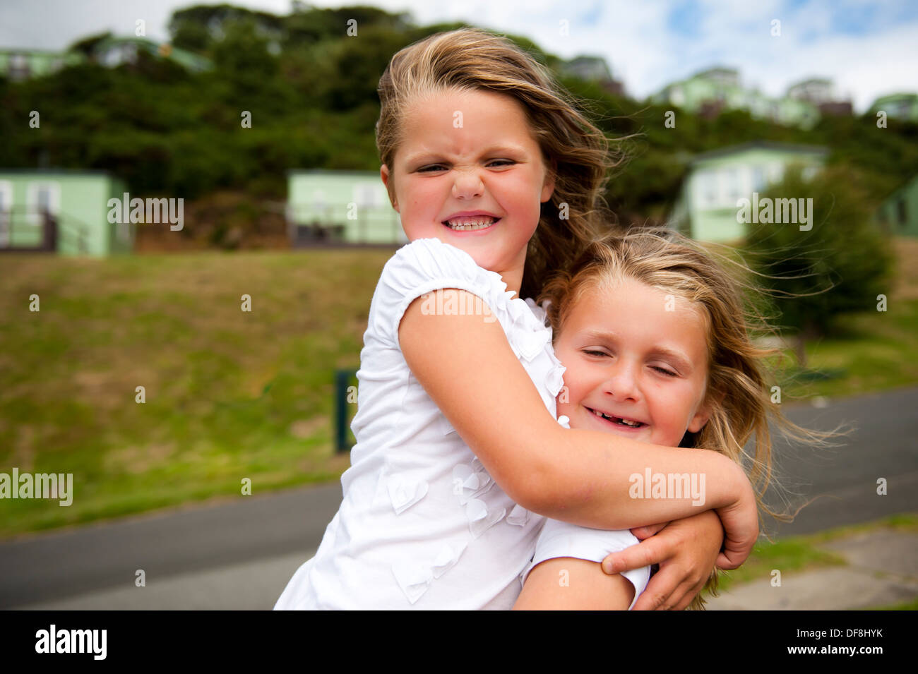 sisters hugging with great facial expressions at caravan holiday park ...