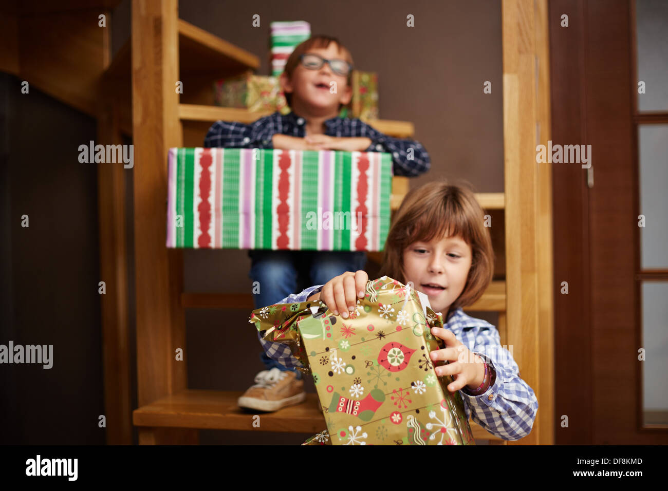 Unwrapping christmas presents children hi-res stock photography and ...