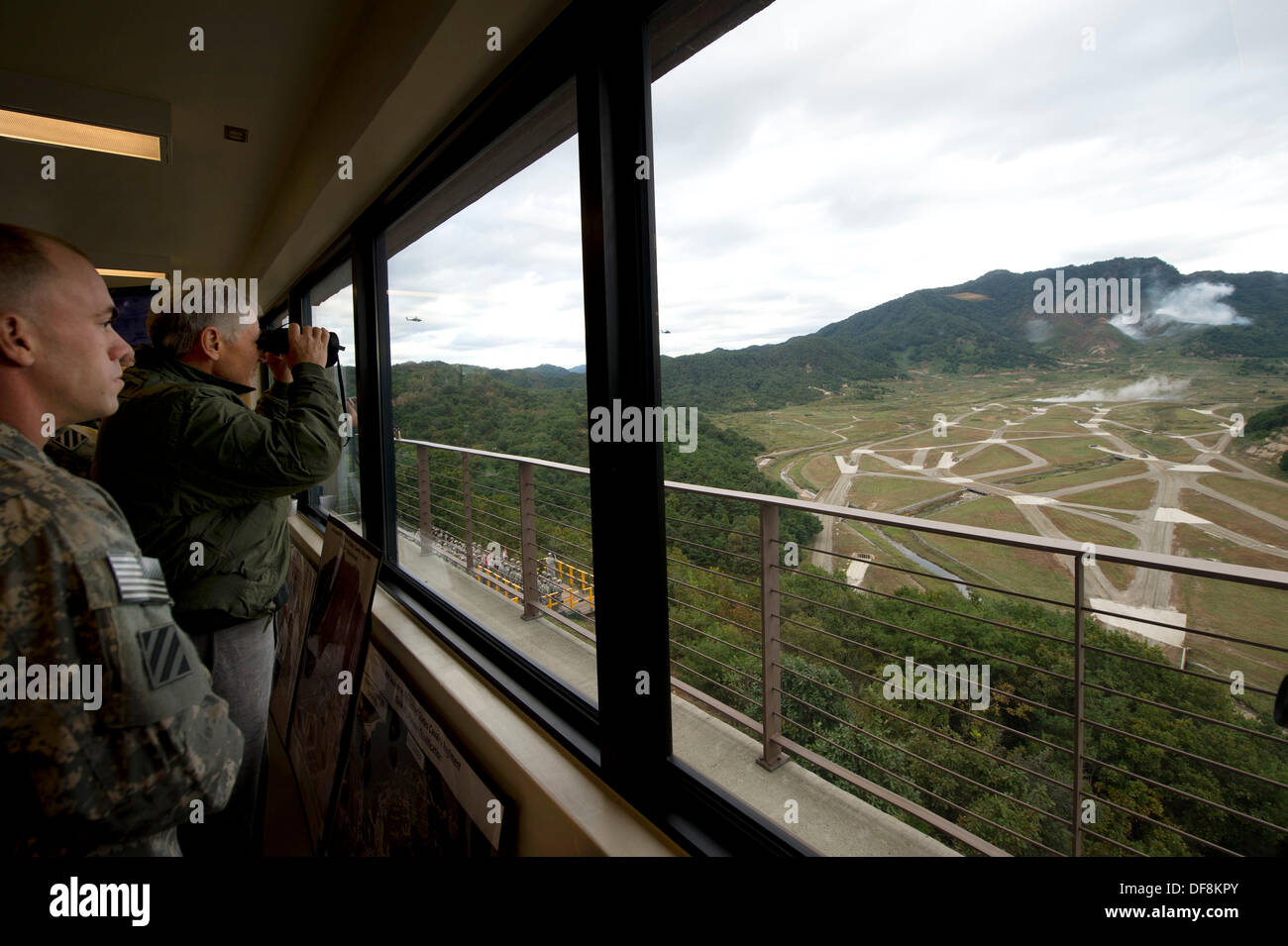 US Secretary of Defense Chuck Hagel observes live fire gunnery training ...