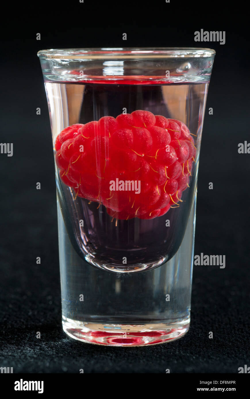 Raspberry shots on a black background Stock Photo - Alamy