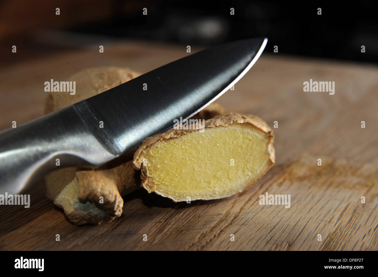Cut fresh ginger with sharp knife Stock Photo - Alamy