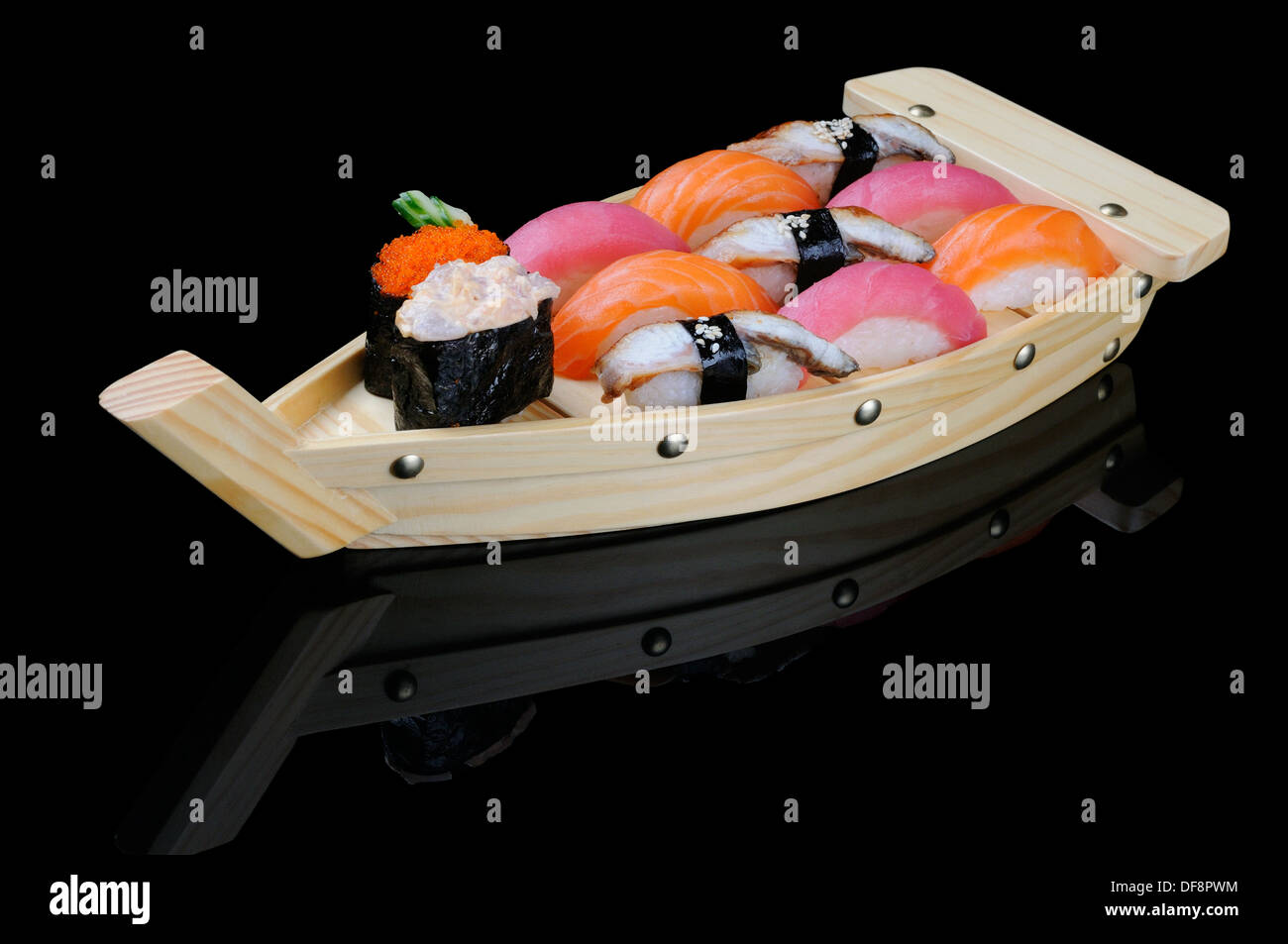 Assortment of sushi served on small wooden boat Stock Photo - Alamy