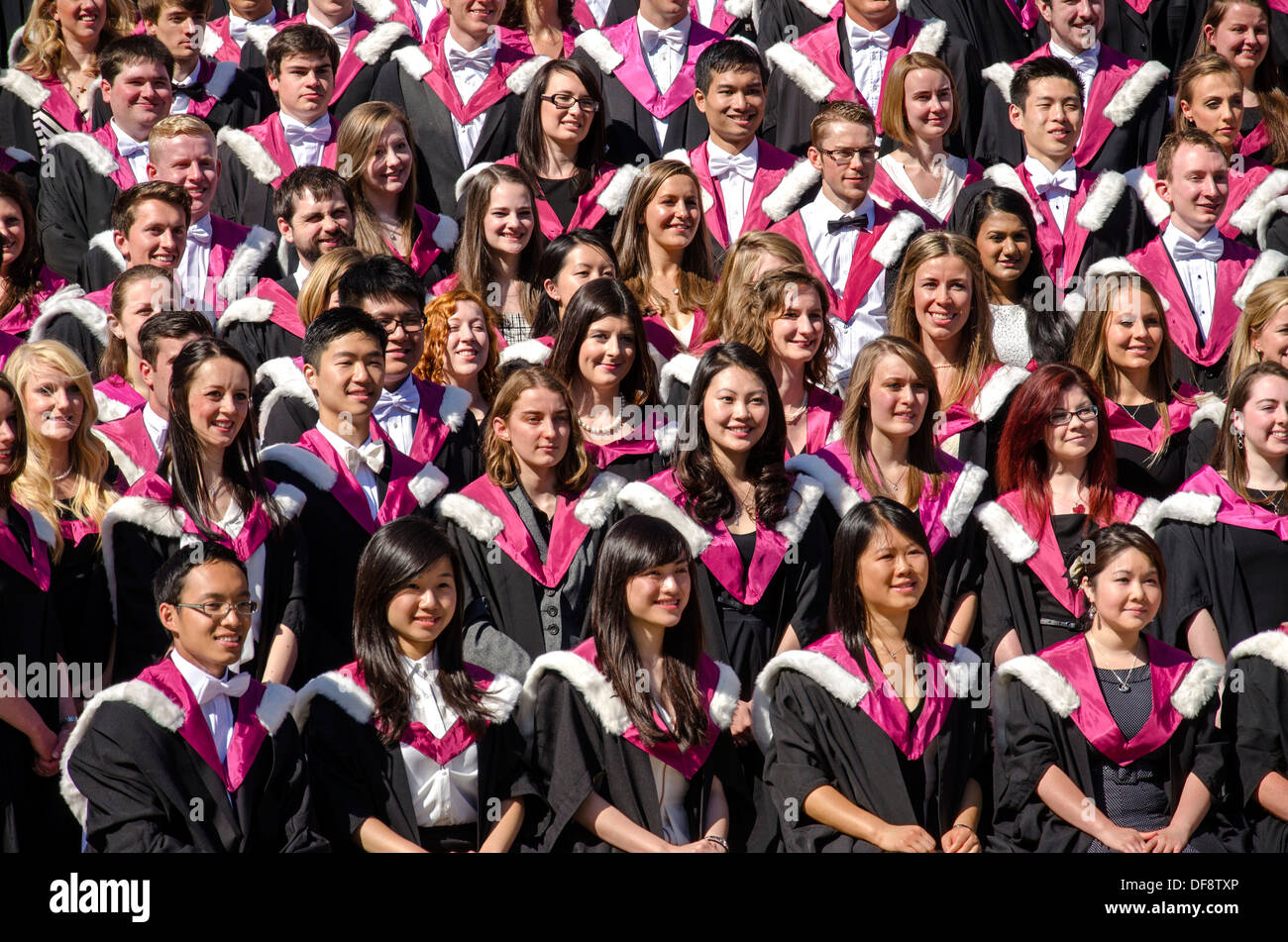 Students sitting for a group photograph after graduating from Edinburgh ...