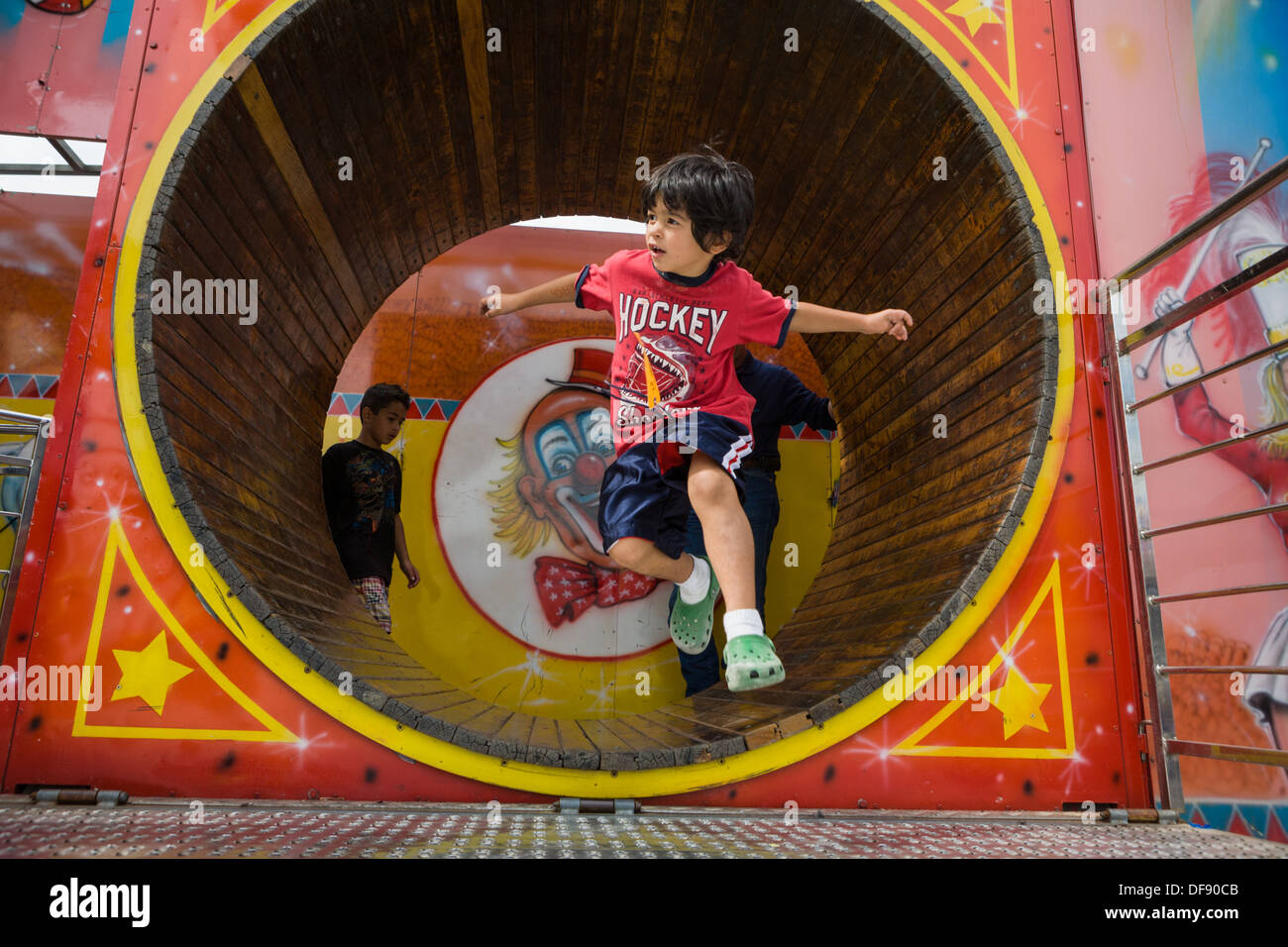 Little boy balancing in rotating tube, Great New York State Fair Stock ...