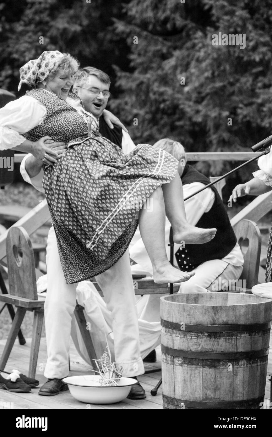 Man loading woman to wooden barrel with cabbage Stock Photo - Alamy