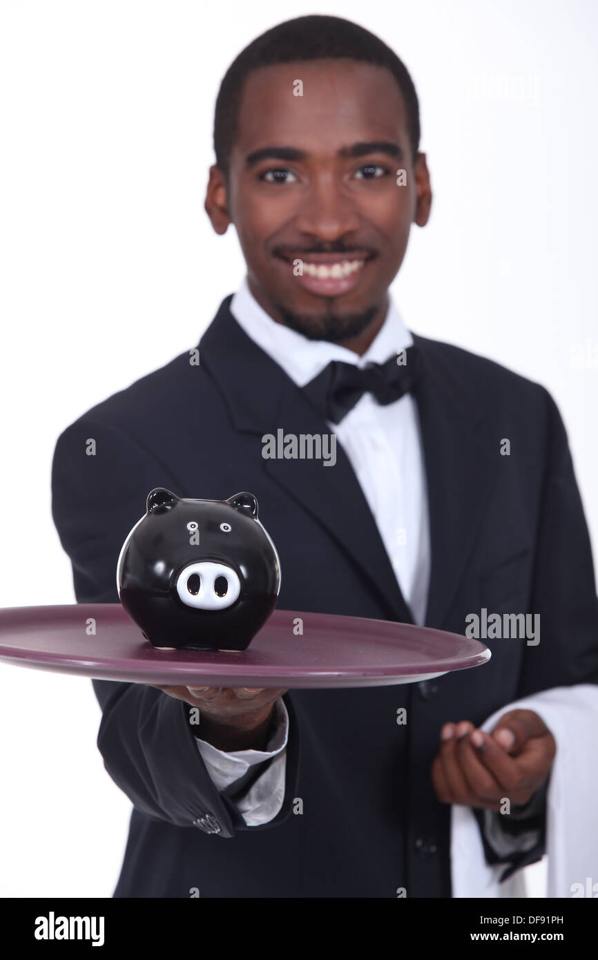Waitor holding piggy bank Stock Photo - Alamy