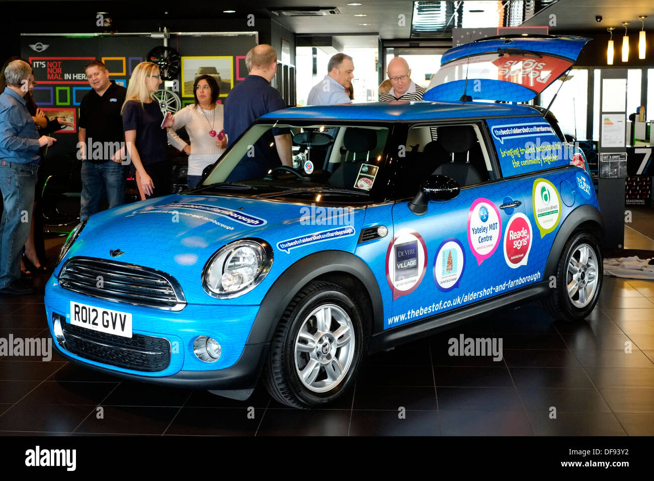 mini car in a showroom after being wrapped with logos for a customer ...