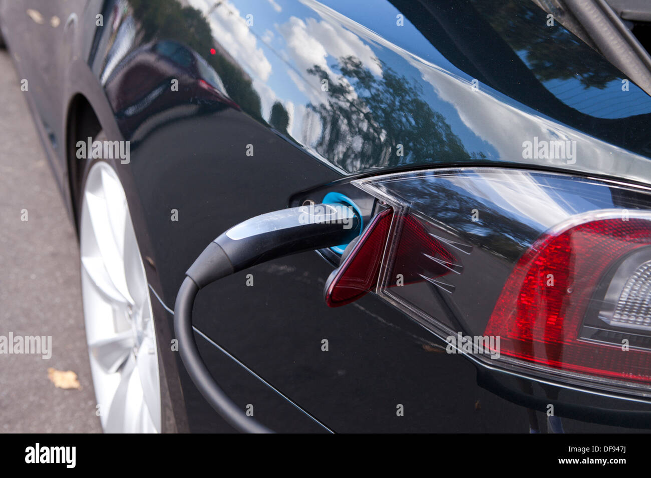 Tesla Model S electric car plugged in Stock Photo - Alamy