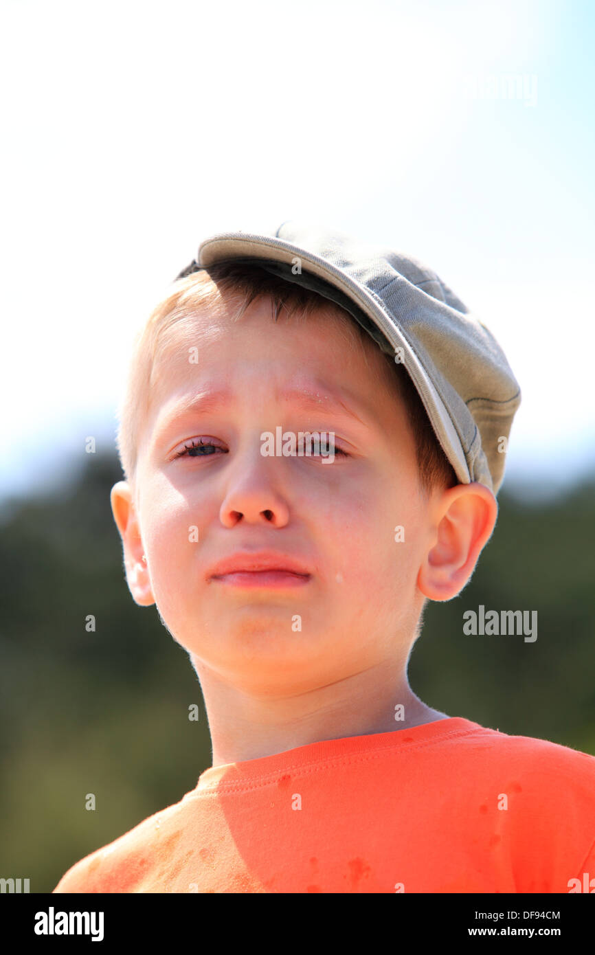 Sad child. Portrait of crying unhappy little boy outdoor Stock Photo ...